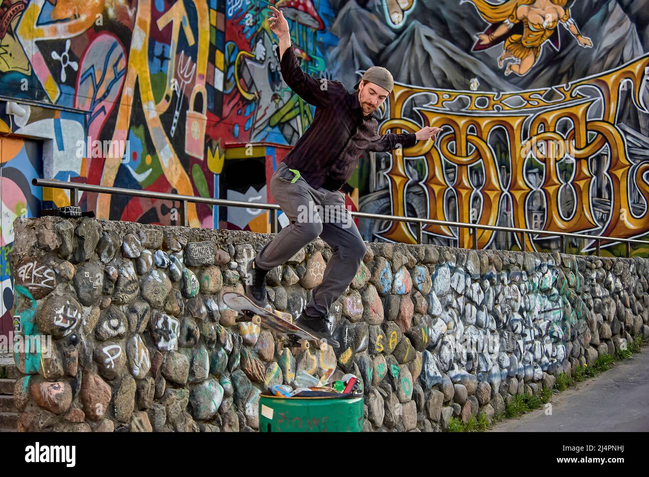 a skateboarder rides a skateboard in a skatepark, does tricks Stock ...