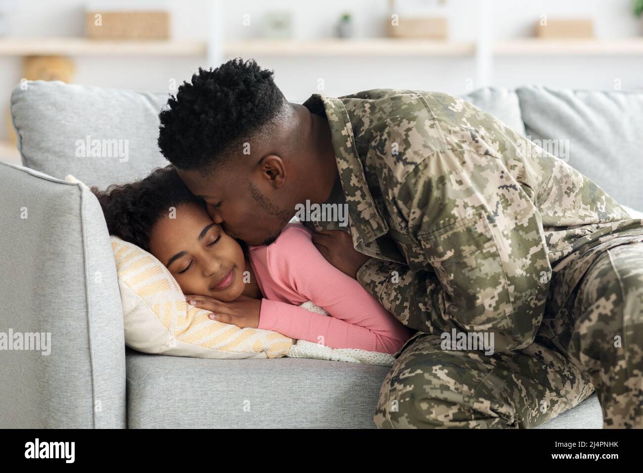 Black man soldier back for military service, kissing sleeping daughter ...
