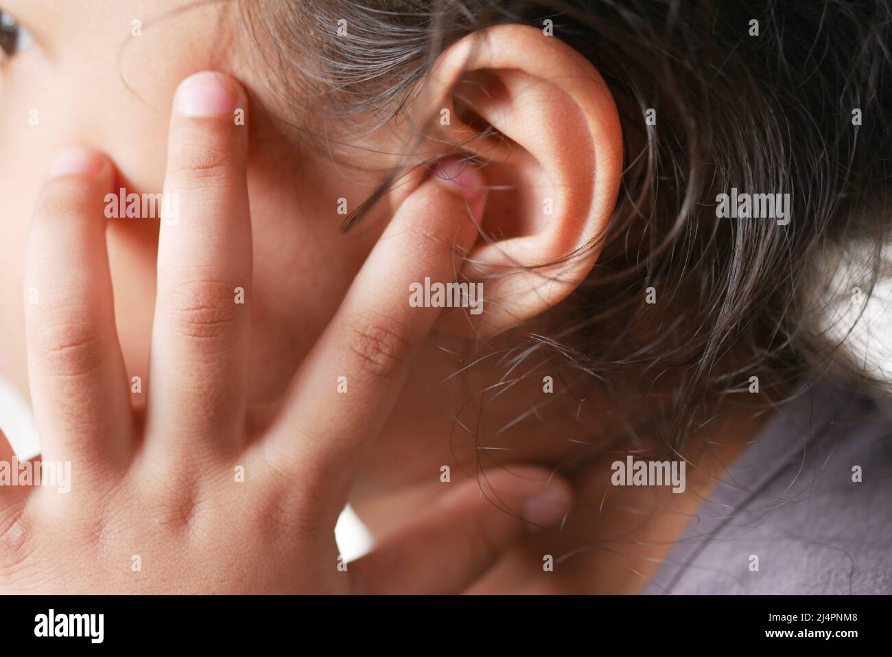 child girl having ear pain touching his painful ear Stock Photo - Alamy
