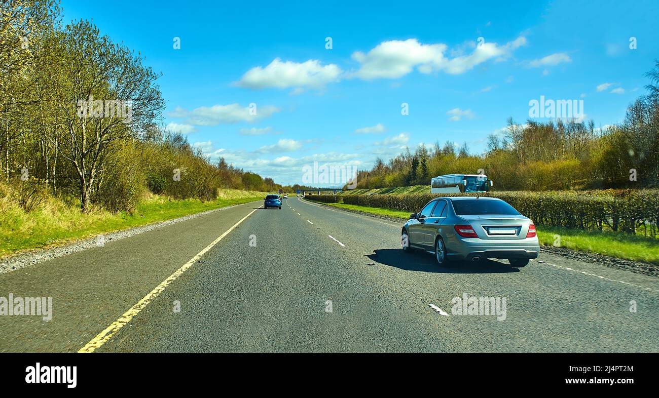 Rear view of cars driving on motorway, Ireland. Road with metal safety ...
