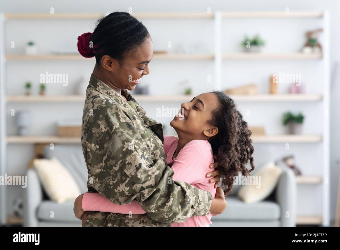 Loving black mother soldier bonding with her cute daughter Stock Photo ...