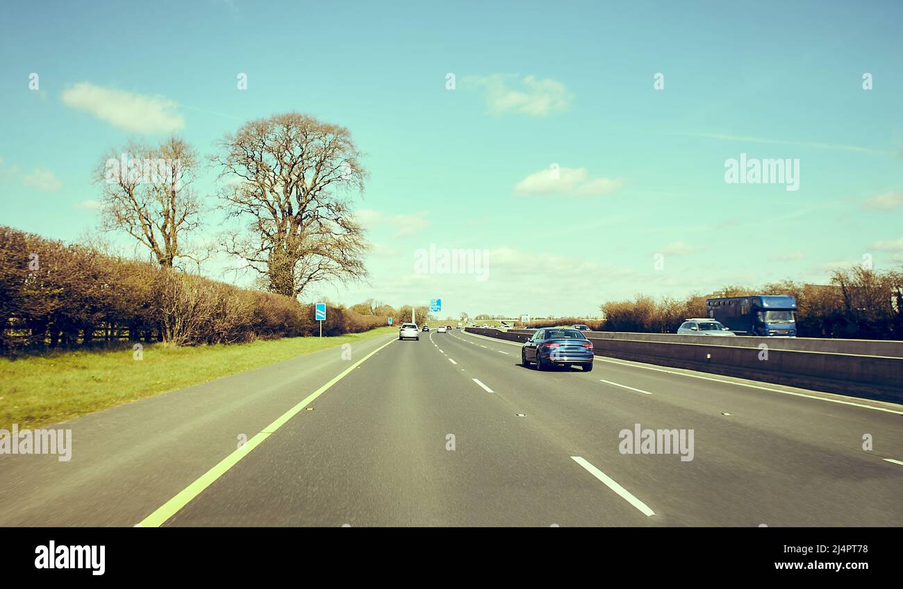 Rear view of cars driving on motorway, Ireland. Road with metal safety ...