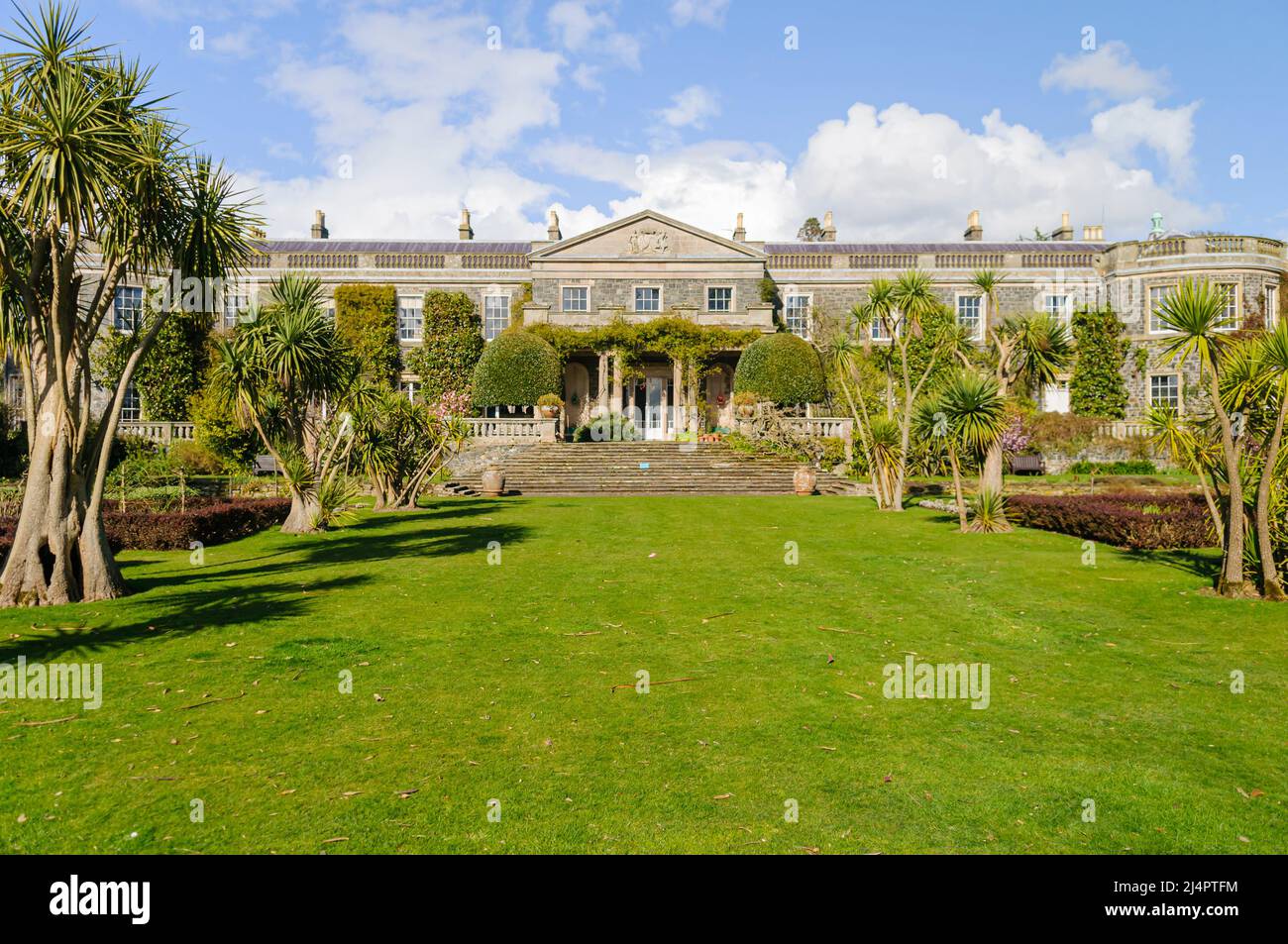 Lawn, palm trees and bushes in the gardens of a stately home Stock ...