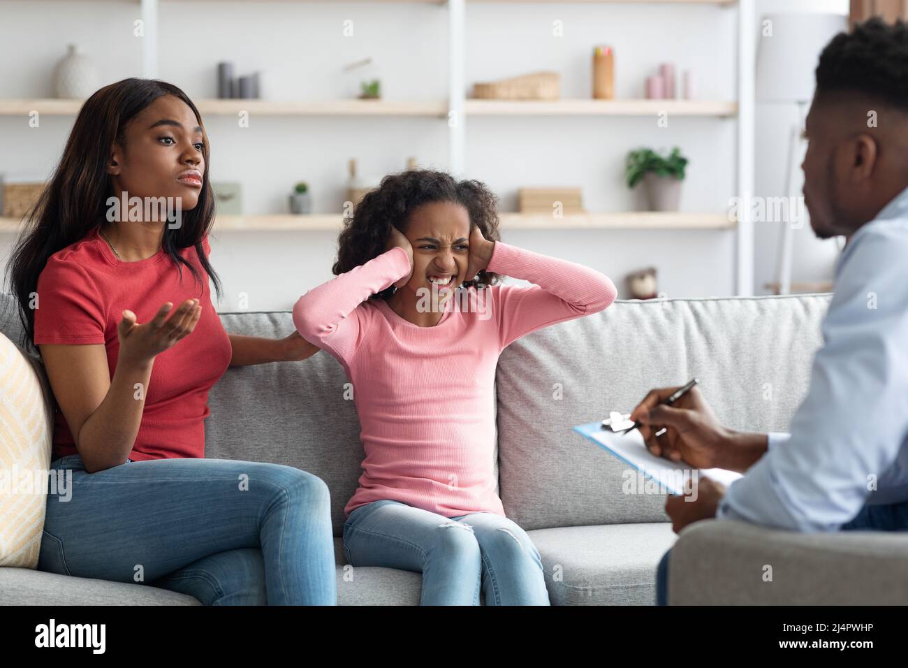 Angry girl with behavioral disorder having therapy session with ...