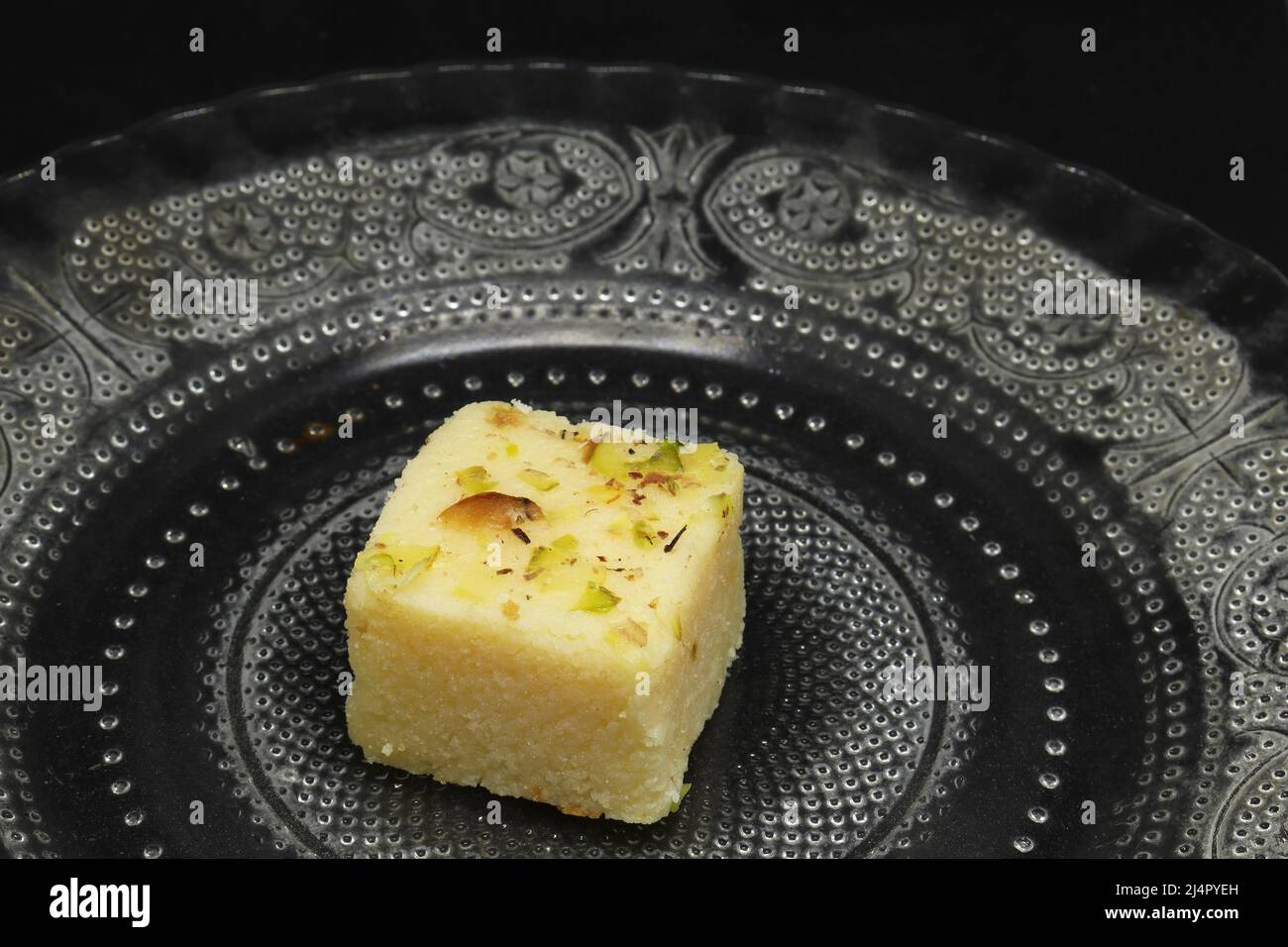 square shape sweets in a plate. on a black background Stock Photo - Alamy