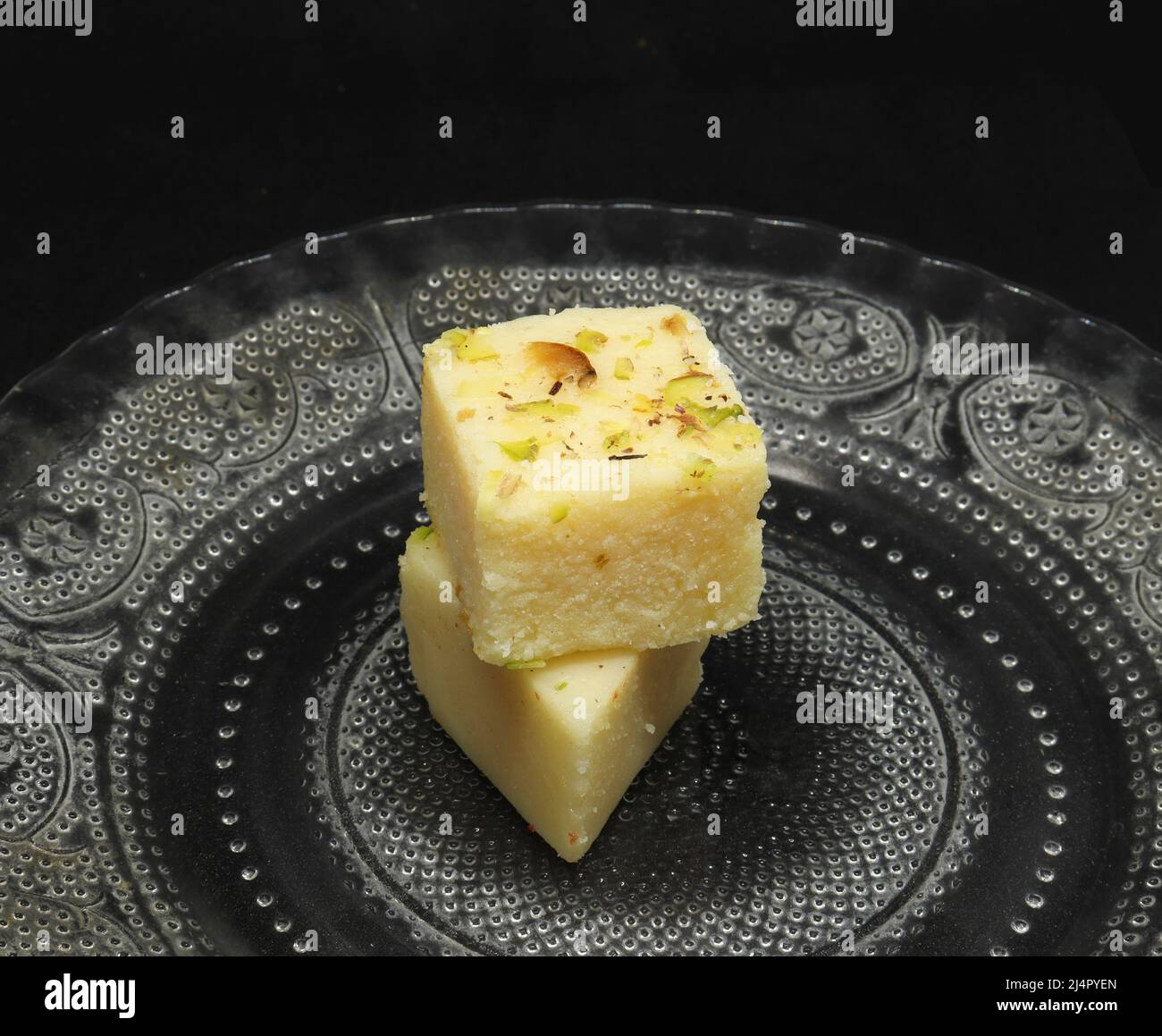 square shape sweets in a plate. on a black background Stock Photo - Alamy