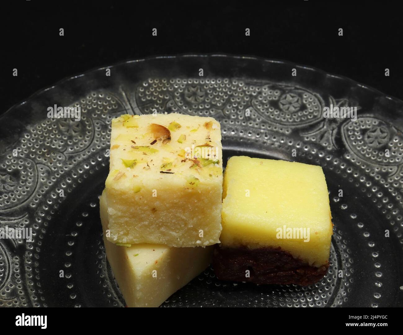 square shape sweets in a plate. on a black background Stock Photo - Alamy
