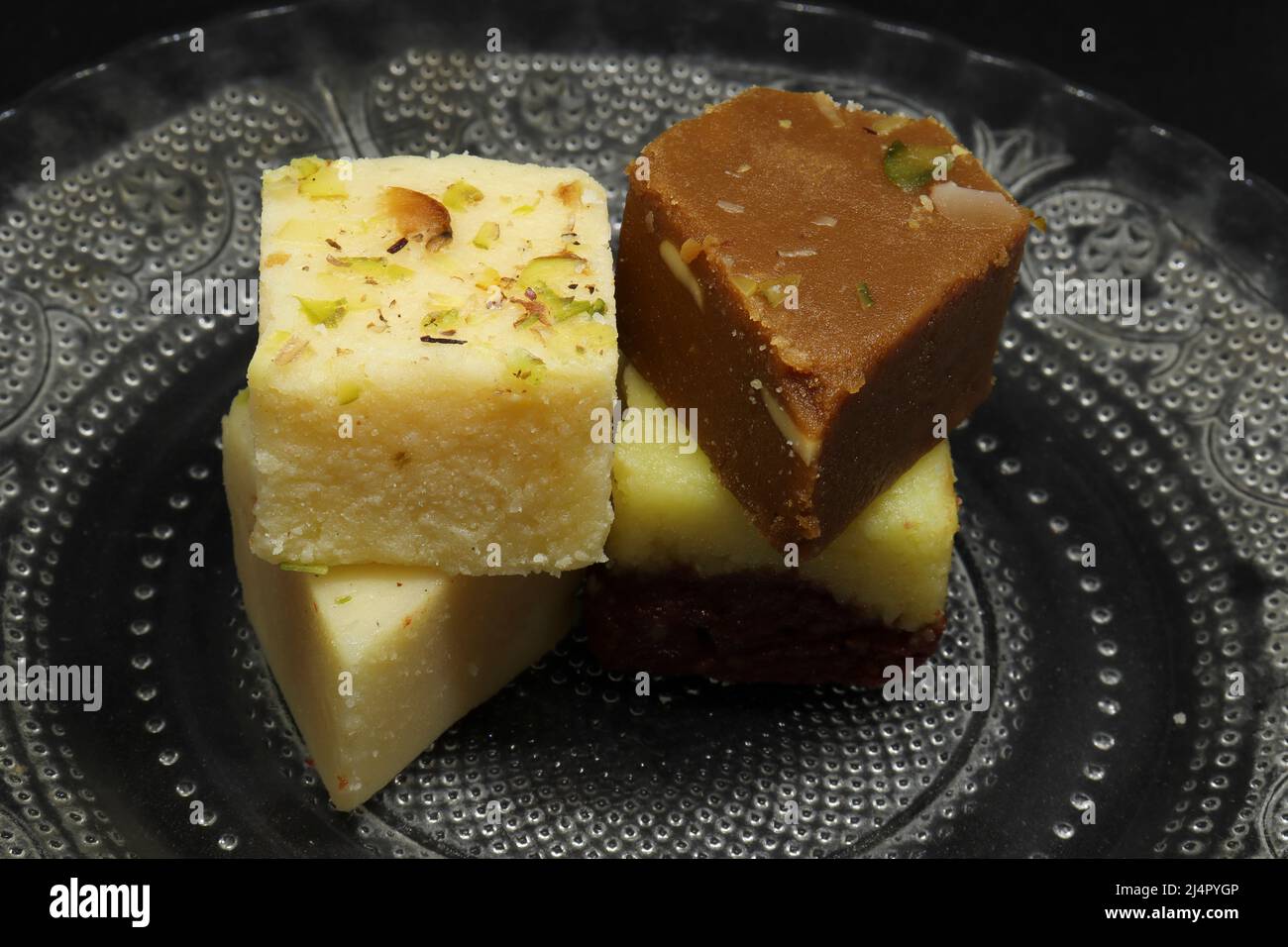 square shape sweets in a plate. on a black background Stock Photo - Alamy