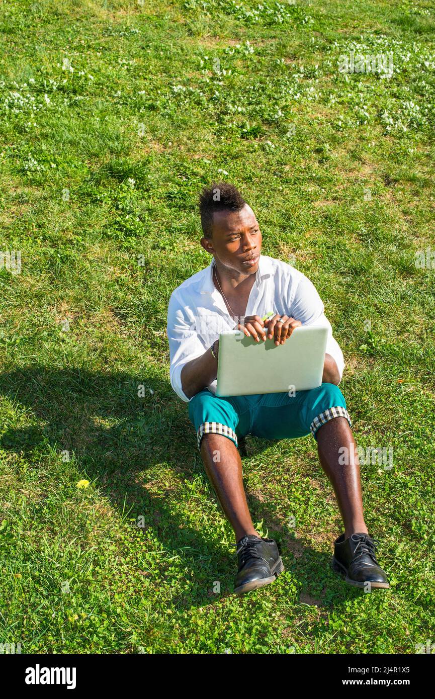 Dressing in a white shirt, green pants and black leather shoes, holding ...