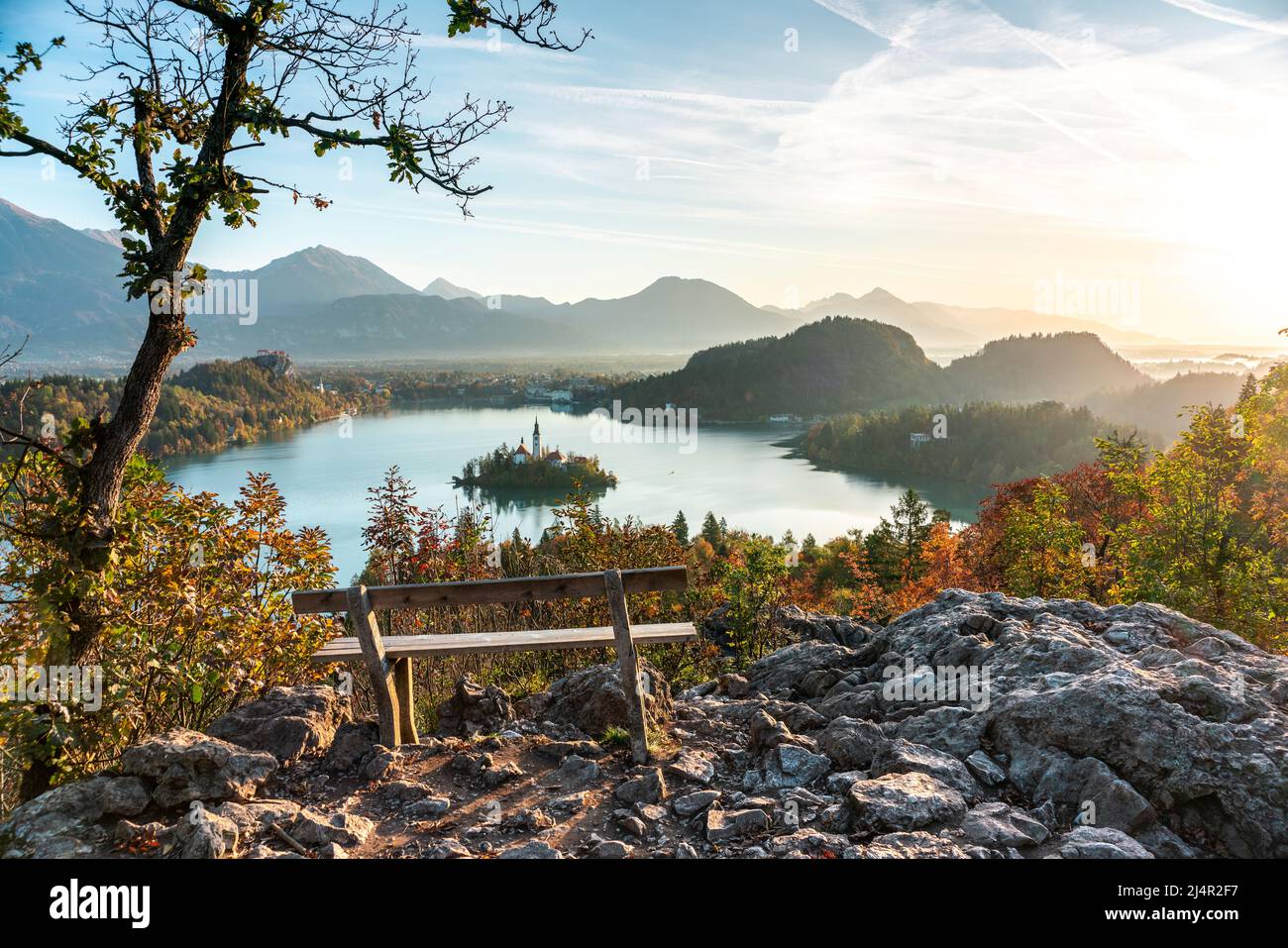 Amazing view of Lake Bled on an autumn morning with a wooden bench in ...