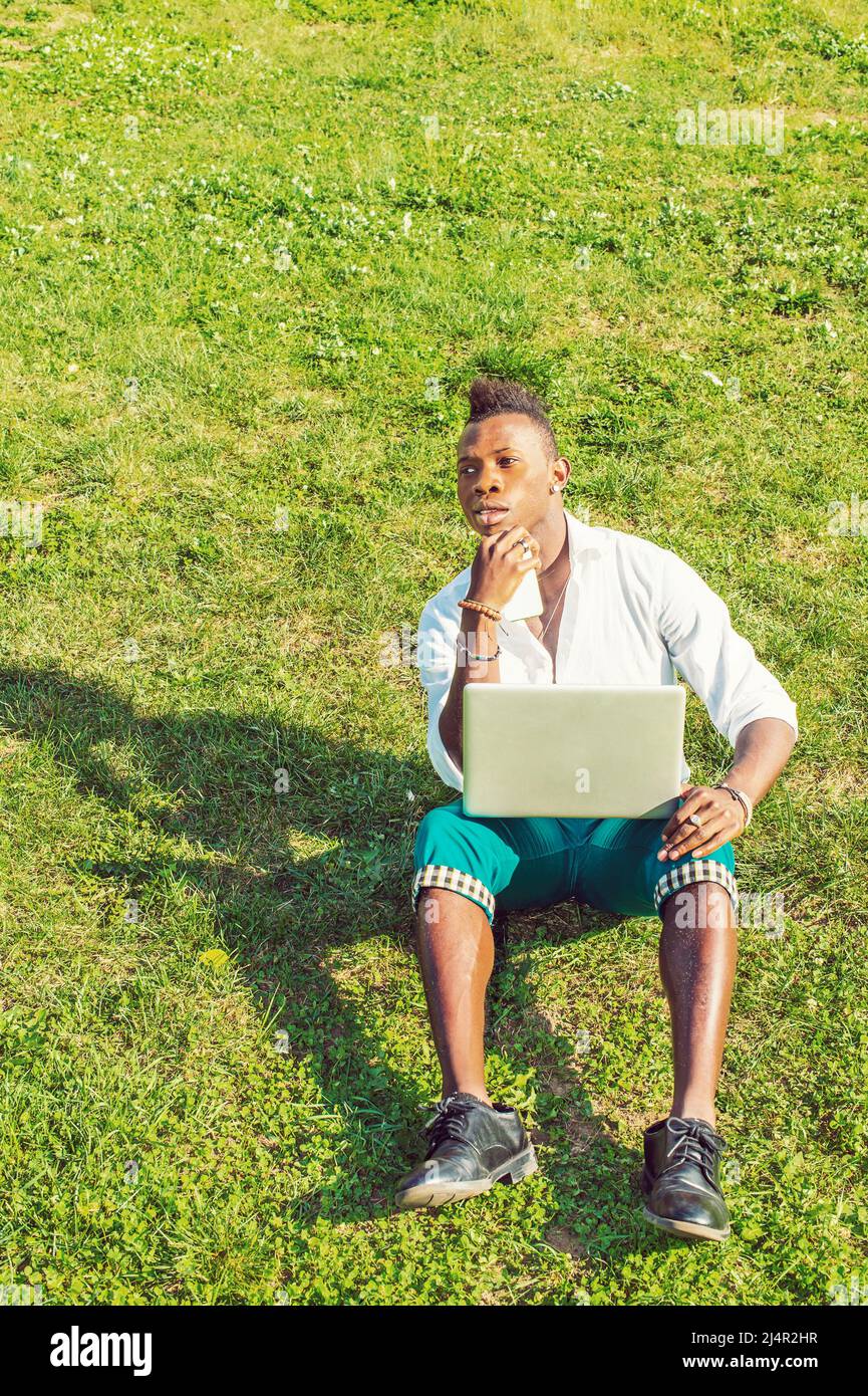 Dressing in a white shirt, green pants, leather shoes, holding a laptop ...