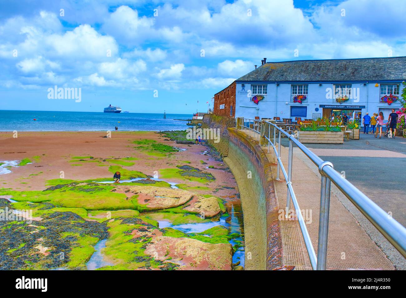 View of Paignton town seaside and beach with a long pier juts out from ...