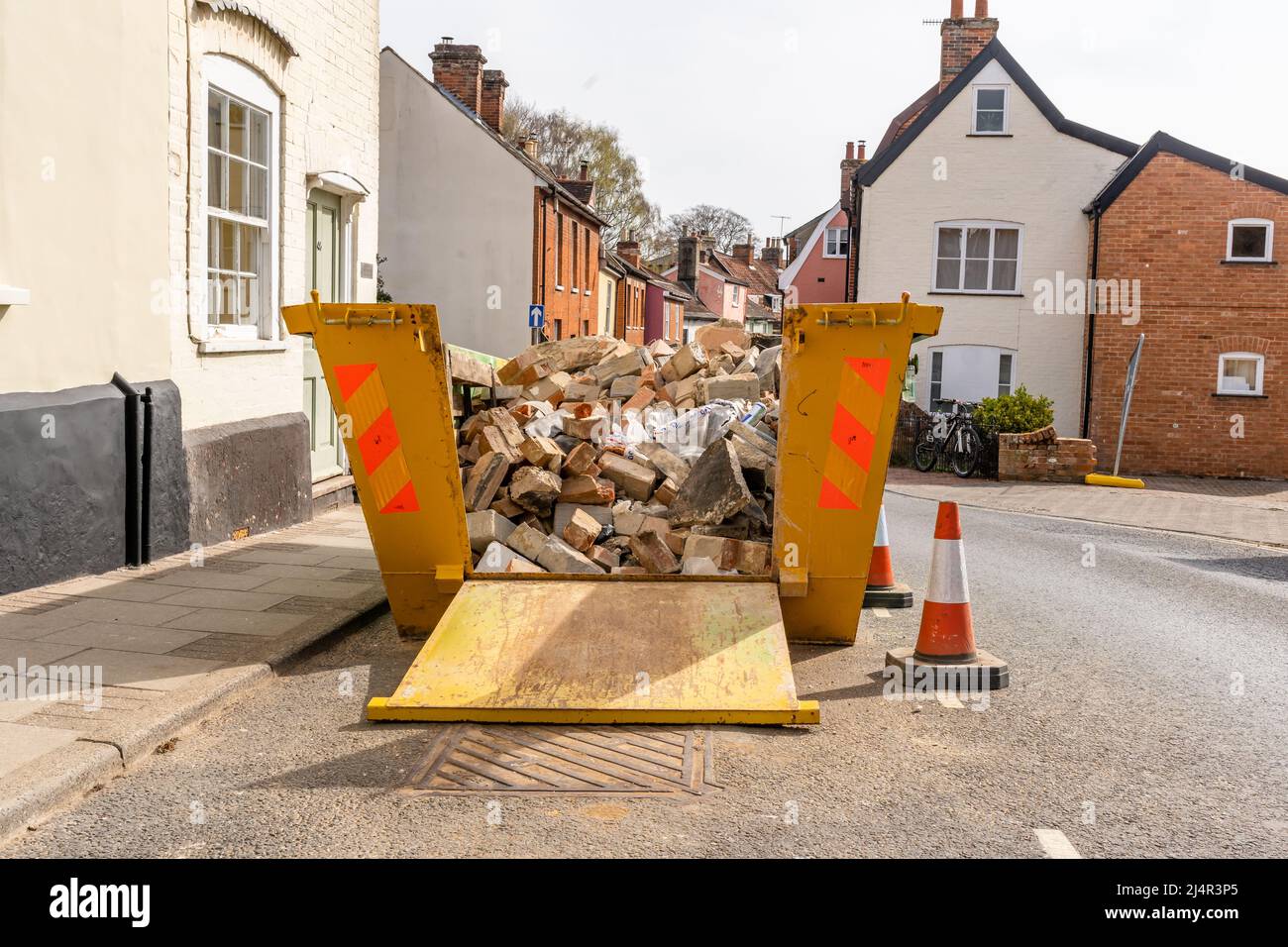 A builders skip containing rubble and bricks from a ongoing home ...