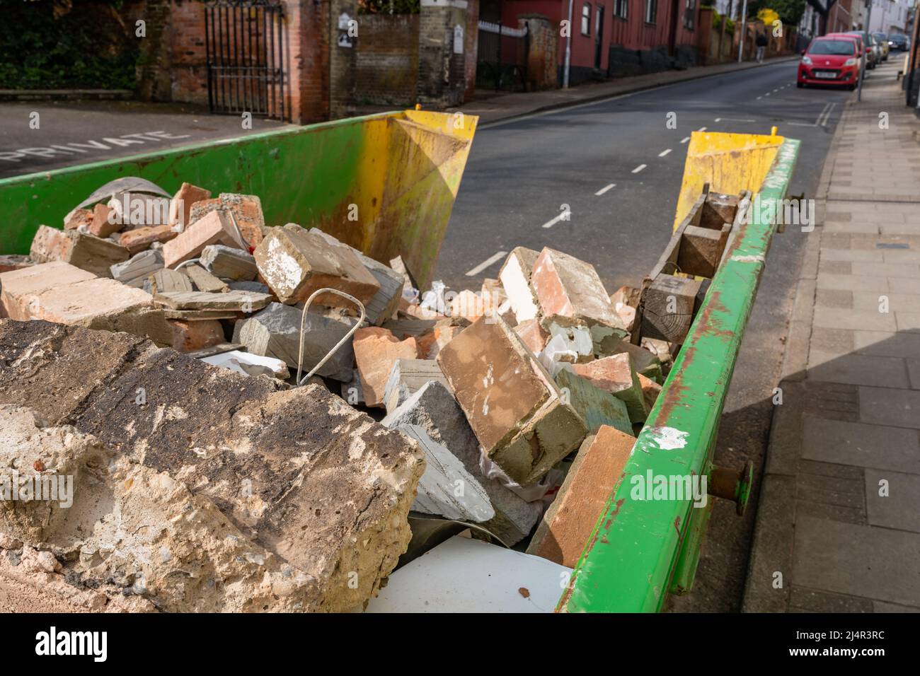 A builders skip containing rubble and bricks from a ongoing home ...
