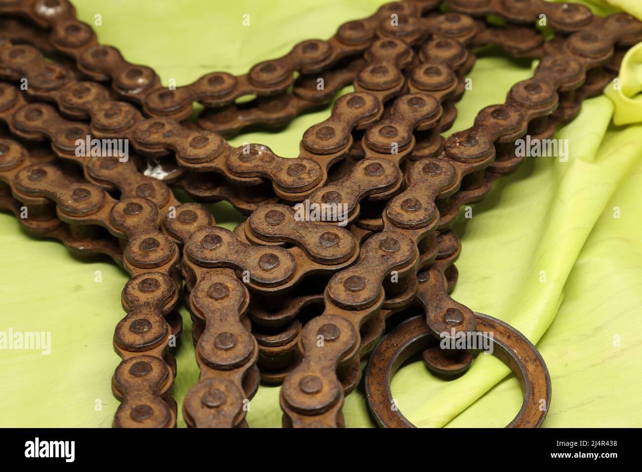 iron metal chain. with green background Stock Photo - Alamy