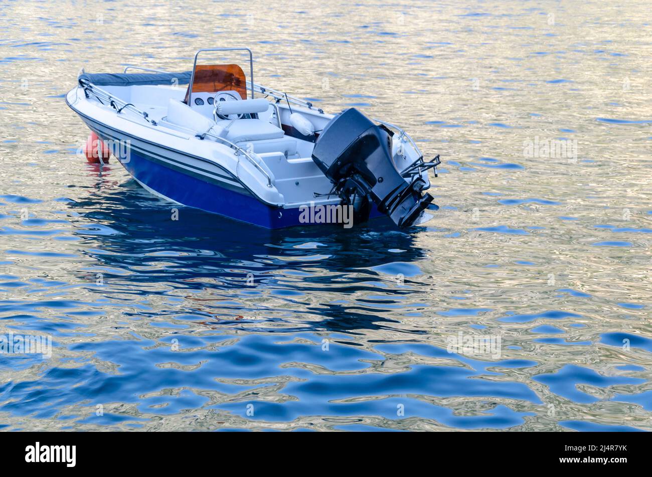 Speedboat on a sea water moored at the buoy Stock Photo - Alamy