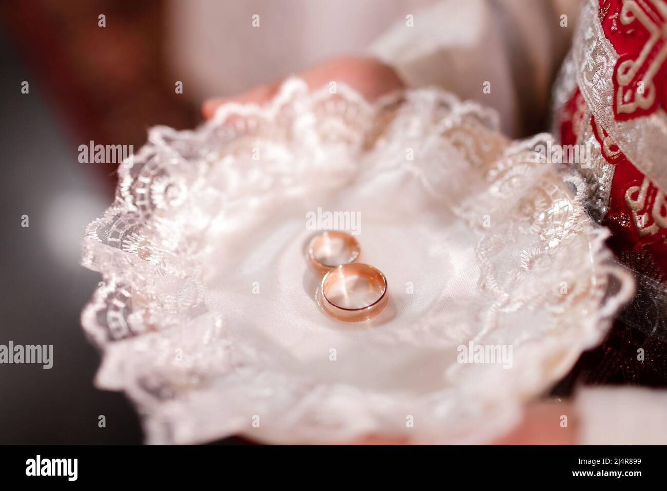 Wedding ceremony in church. Priest holding plate with stylish wedding ...