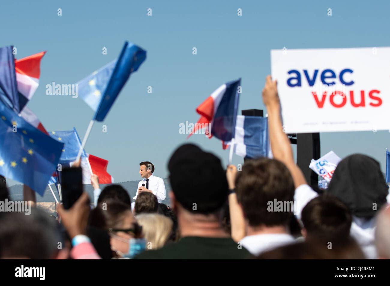Emmanuel Macron is seen on stage giving his speech with supporters ...