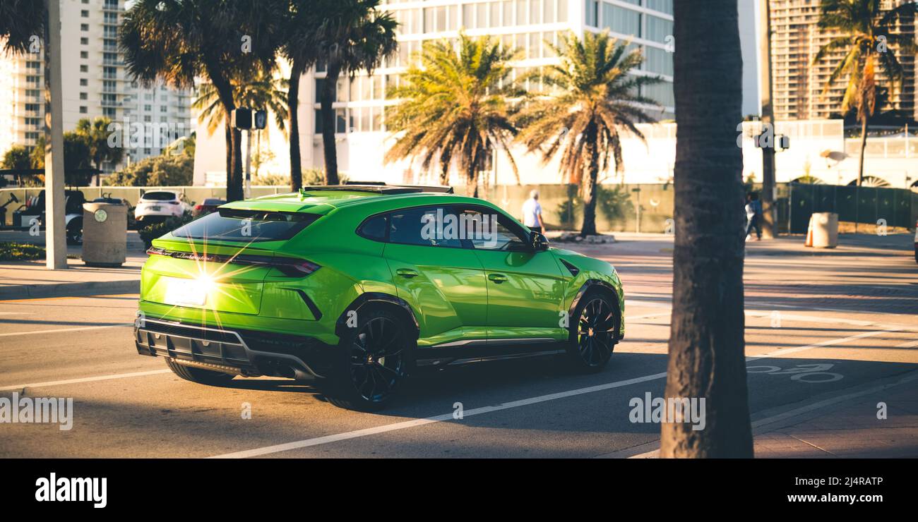 A bright green Lamborghini Urus reflects sunlight in Fort Lauderdale ...