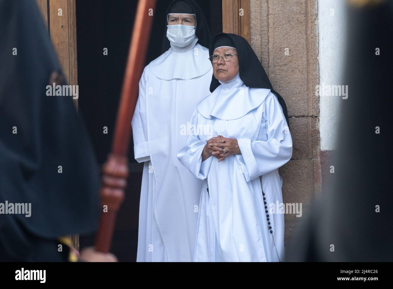 Patzcuaro, Mexico. 16th Apr, 2022. Dominican nuns watch as hooded ...