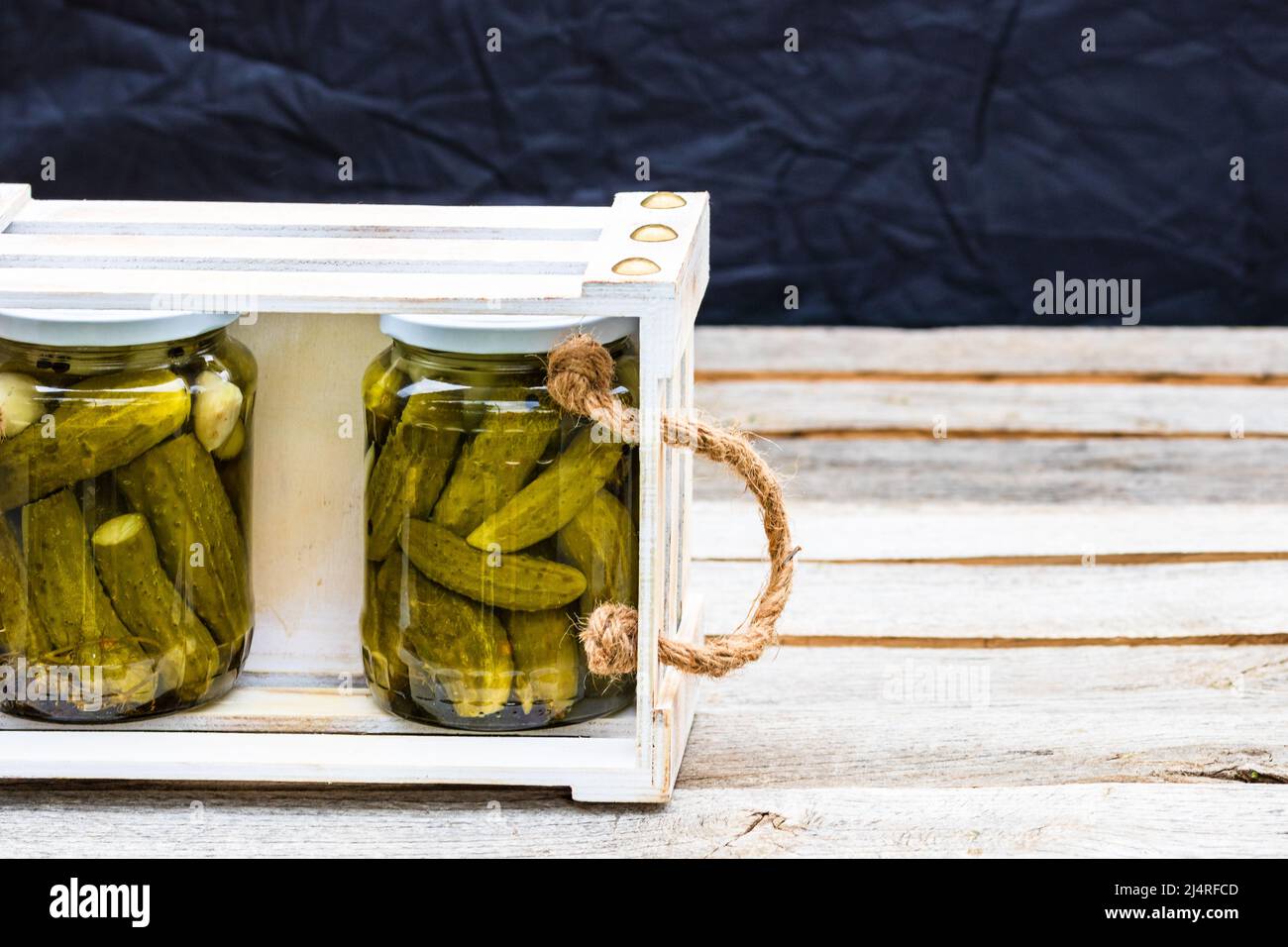 Wooden crate with glass jars with pickles isolated. Preserved food ...