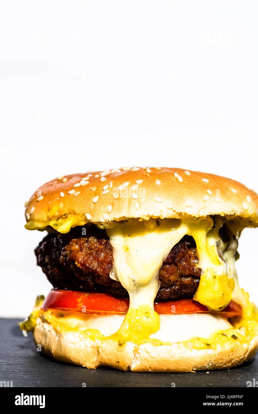 Beef cheeseburger with melting cheese. Tasty homemade cheeseburger ...