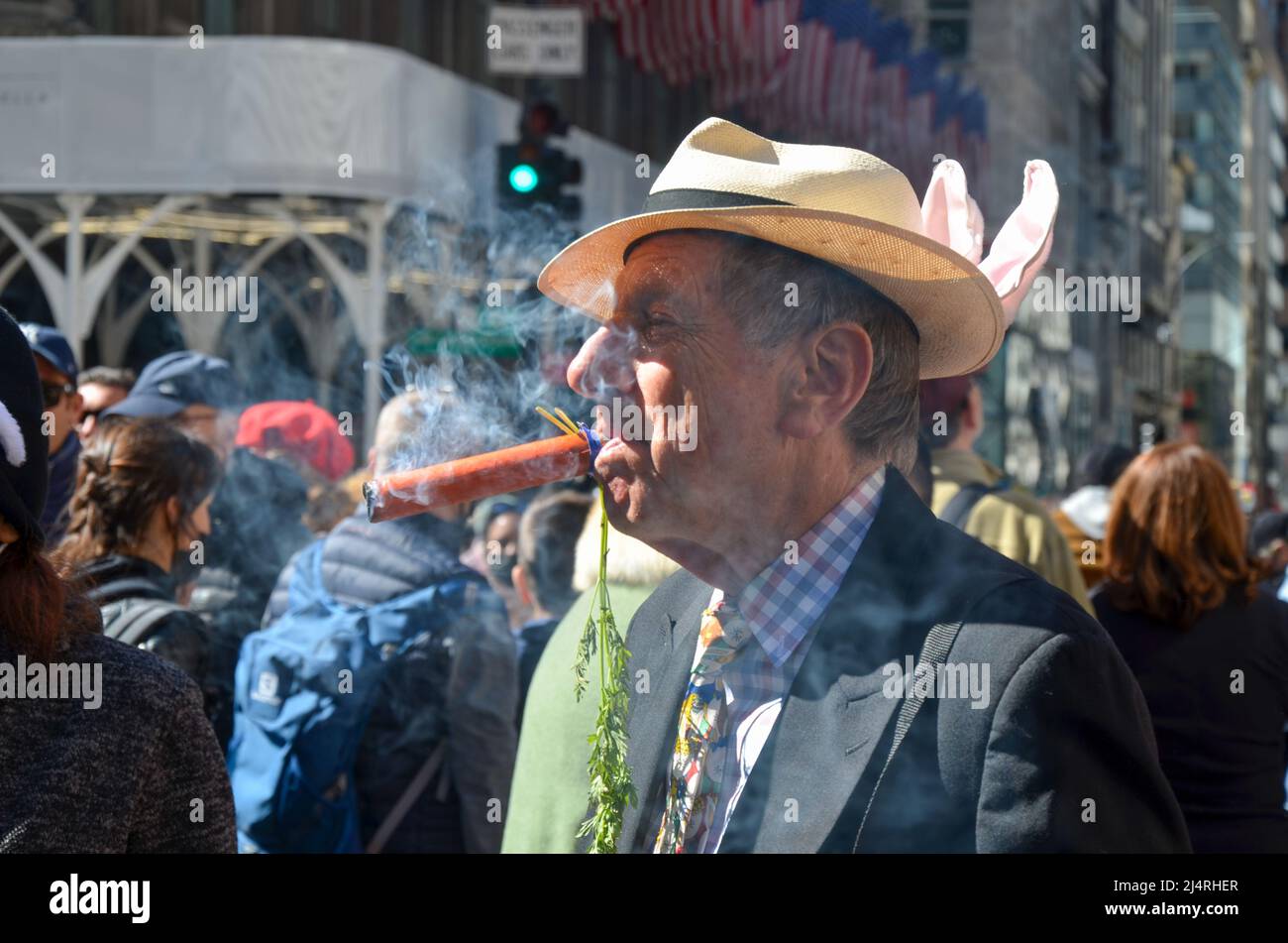A man is seen with colorful hat, smoking a cigar at the annual Easter ...