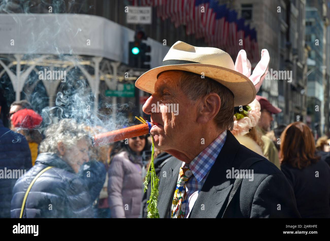 A man is seen with colorful hat, smoking a cigar at the annual Easter ...