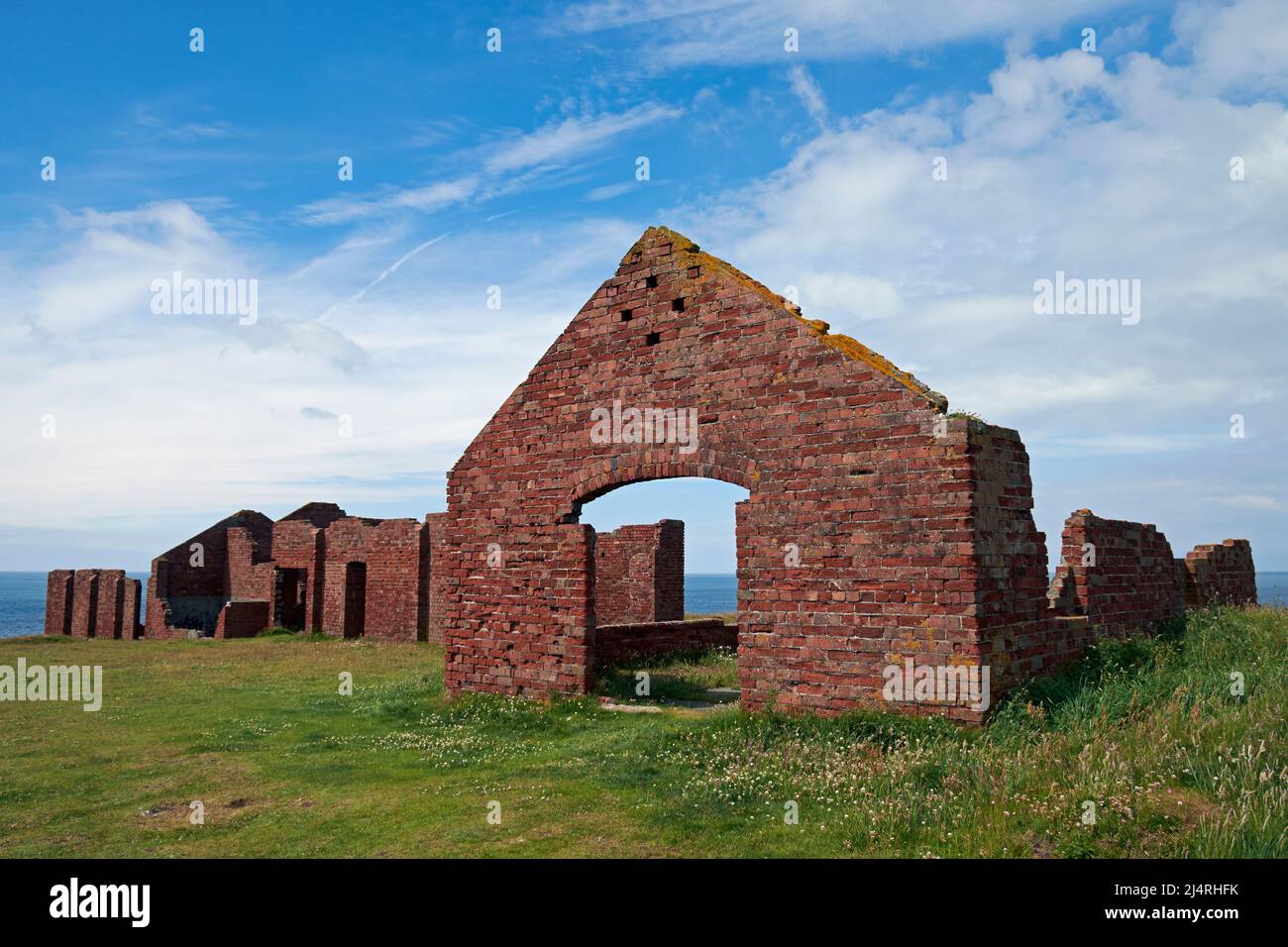 Derelict quarry buildings on the clifftop above Porthgain harbour ...