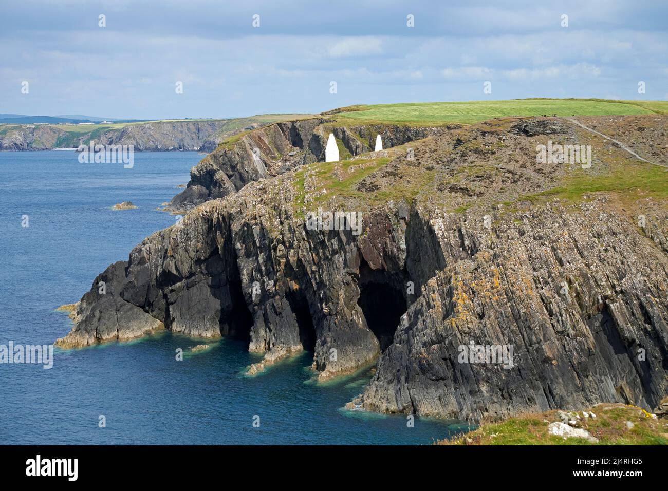Two distant clifftop stone cairns marking the approach to Porthgain ...