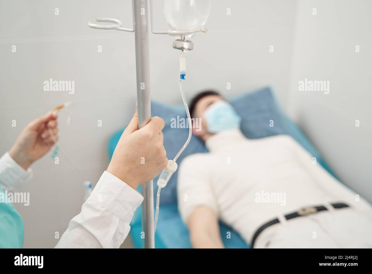 Man during in bed drip procedure in hospital Stock Photo - Alamy