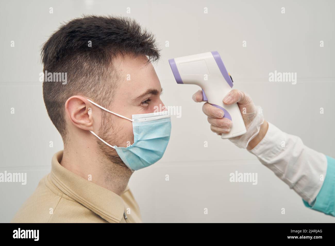 Young man visiting clinic for taking temperature Stock Photo - Alamy