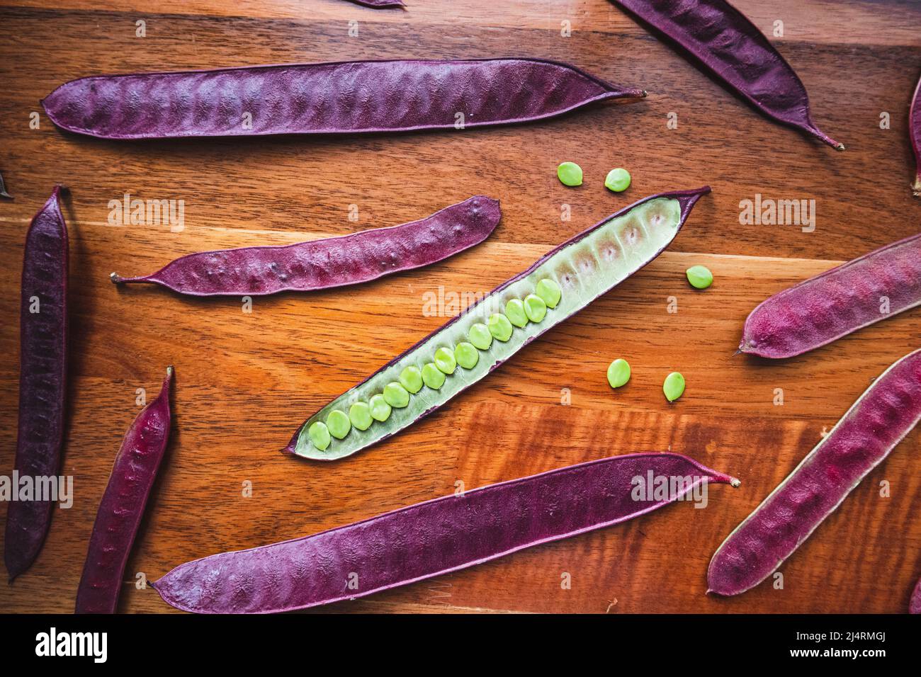 Guaje seed pods scattered on a wood table in a pattern Stock Photo - Alamy
