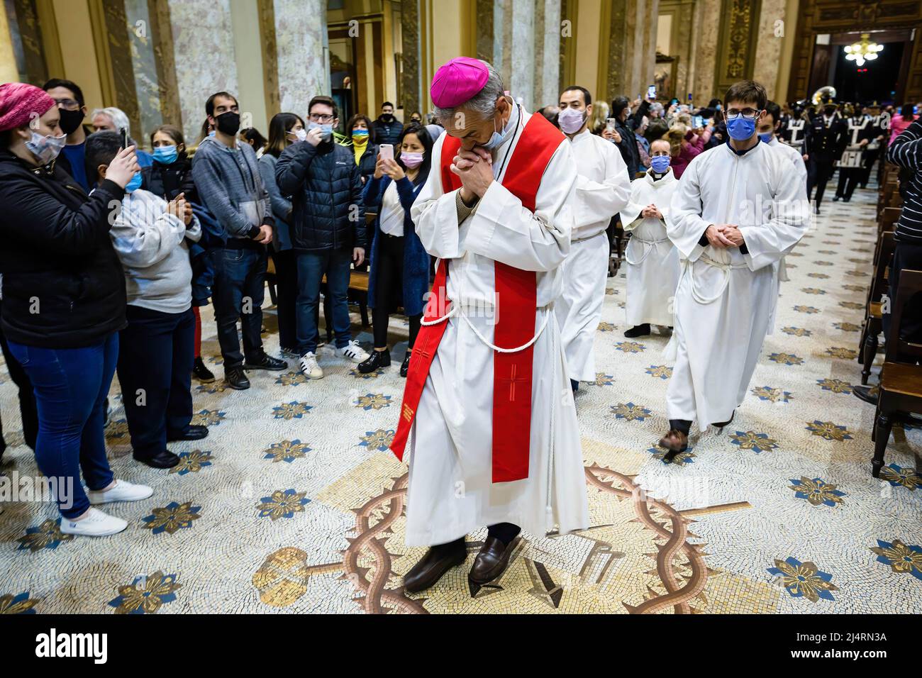 A cardinal is seen praying accompanied by the other devotees in the ...