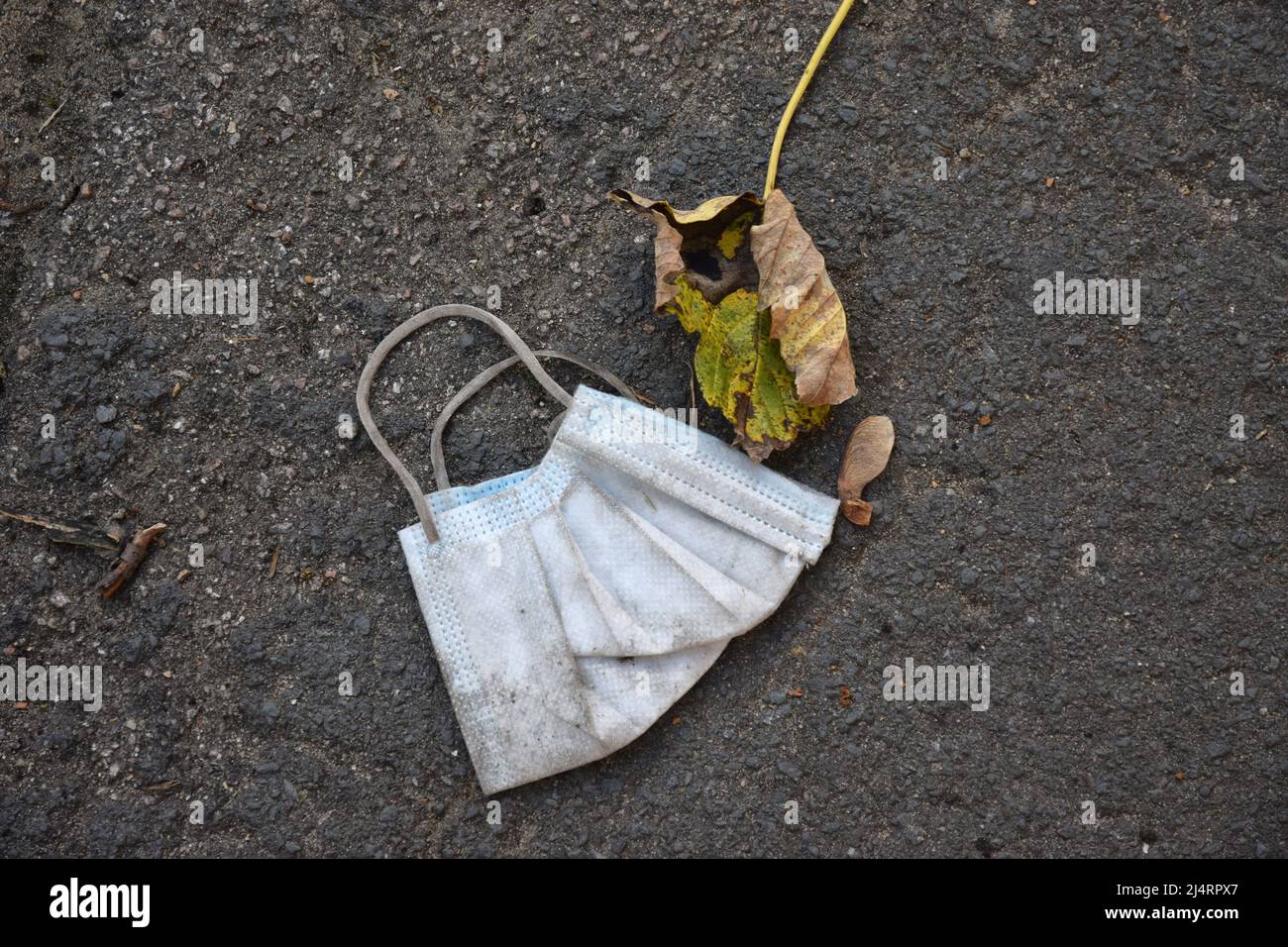 surgical mask on the ground, england Stock Photo - Alamy