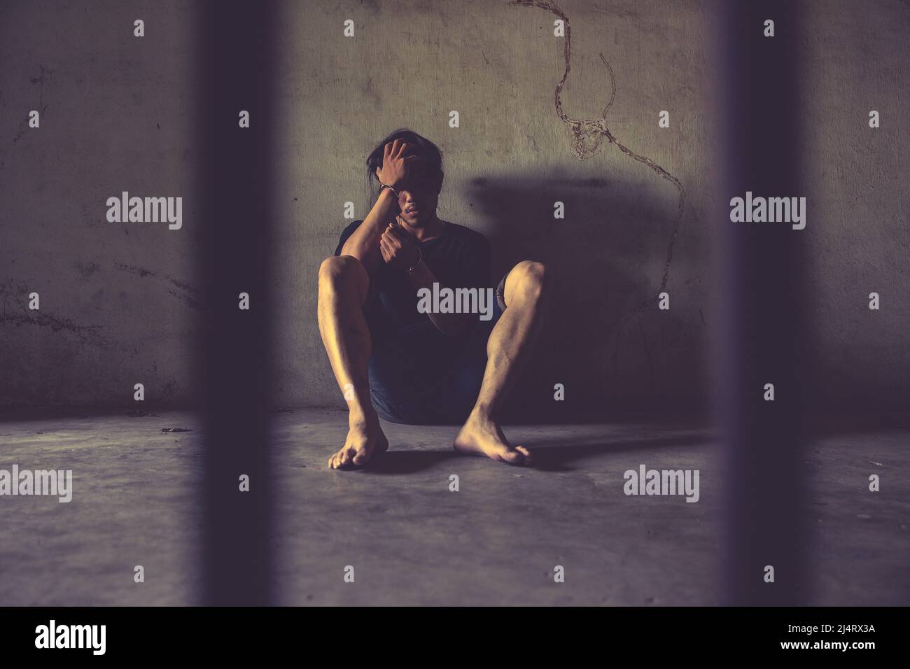 criminal tying hands with handcuffs Stock Photo - Alamy