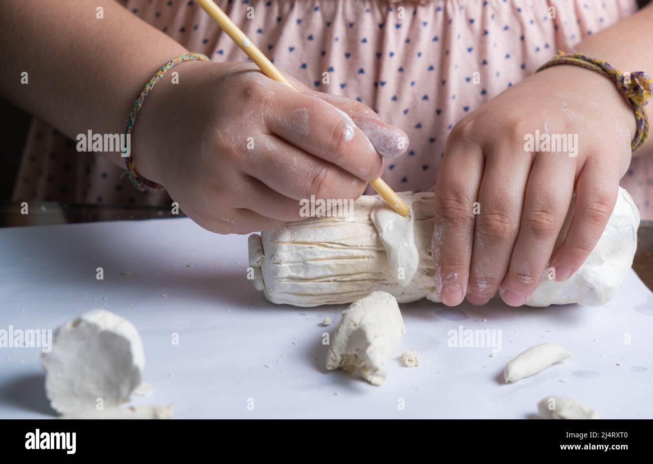 Close-up of a girl's hands making a figure with clay. children's crafts ...