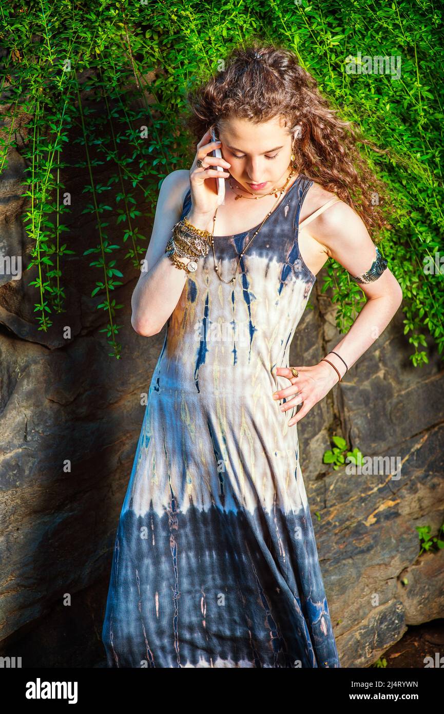 Girl Making Phone Call. A hand holding a cell phone, a hand resting on ...