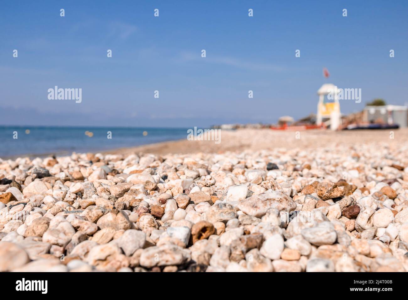 Empty part of the beach in Greece. Sand pebbles and sea background ...