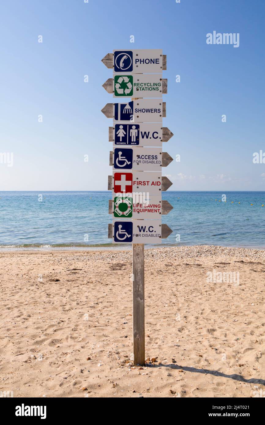 Wooden signpost on the beach in Greece with directional information ...