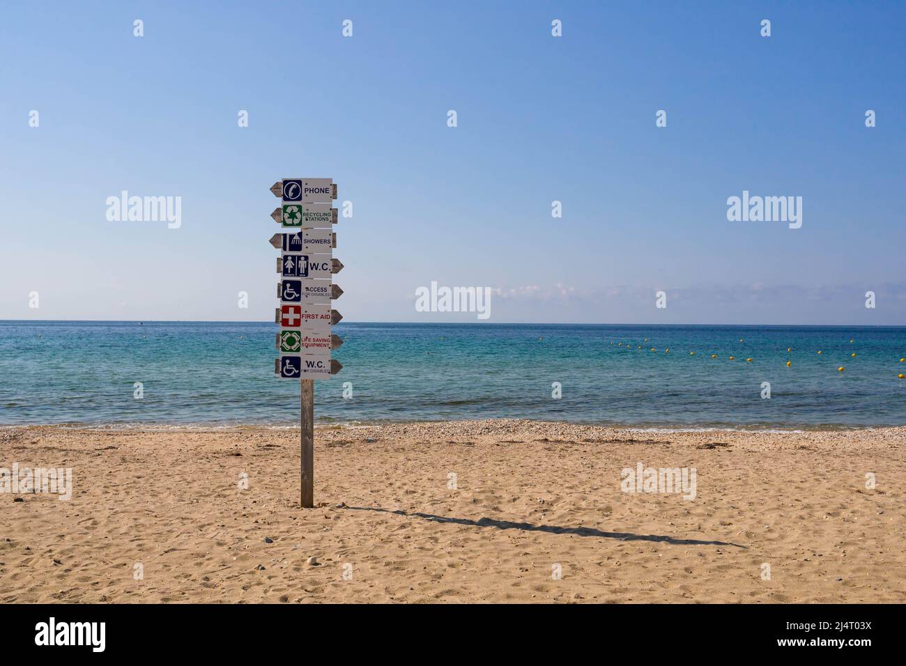 Wooden signpost on the beach in Greece with directional information ...