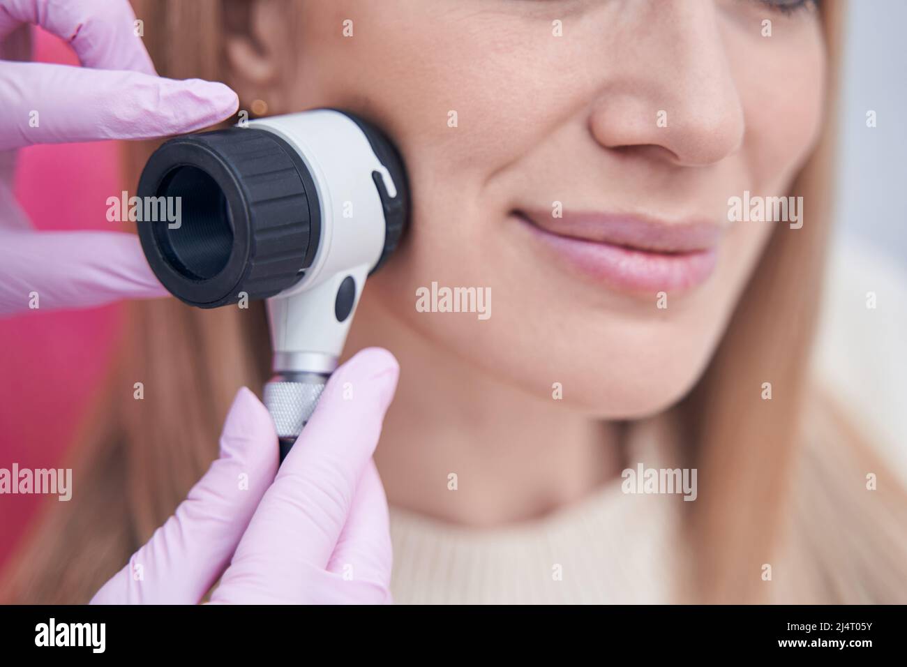 Dermatologist Using Dermoscopy Device During Patient Skin Check Stock