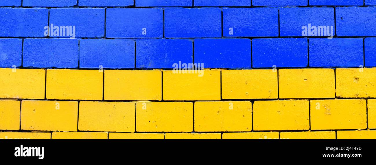 Flag of Ukraine, banner. Brick wall painted in national Ukrainian blue ...