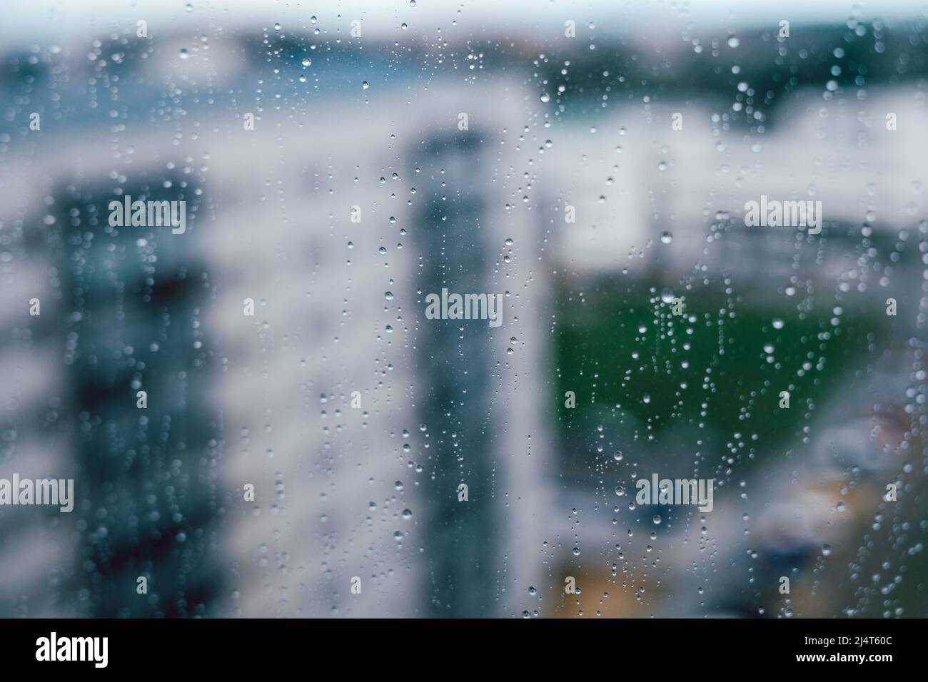 Rain on the city with raindrops on a glass against some buildings Stock ...