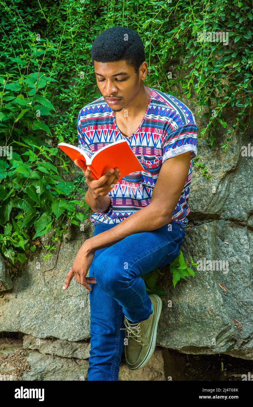 African man sitting reading book hi-res stock photography and images ...