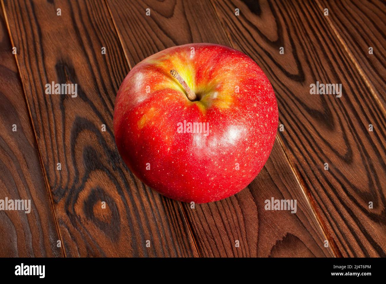 red apples on brown wood background Stock Photo - Alamy