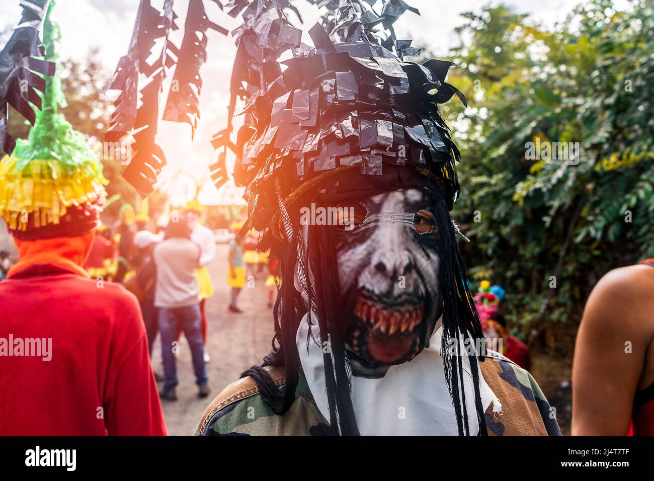 Close-up of a masked latino man with a colorful costume participating ...