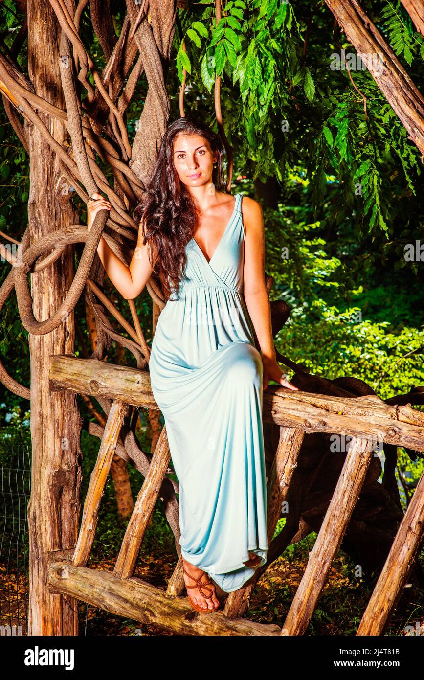 Portrait of Pretty Lady. Dressing in a light blue long dress, a young ...