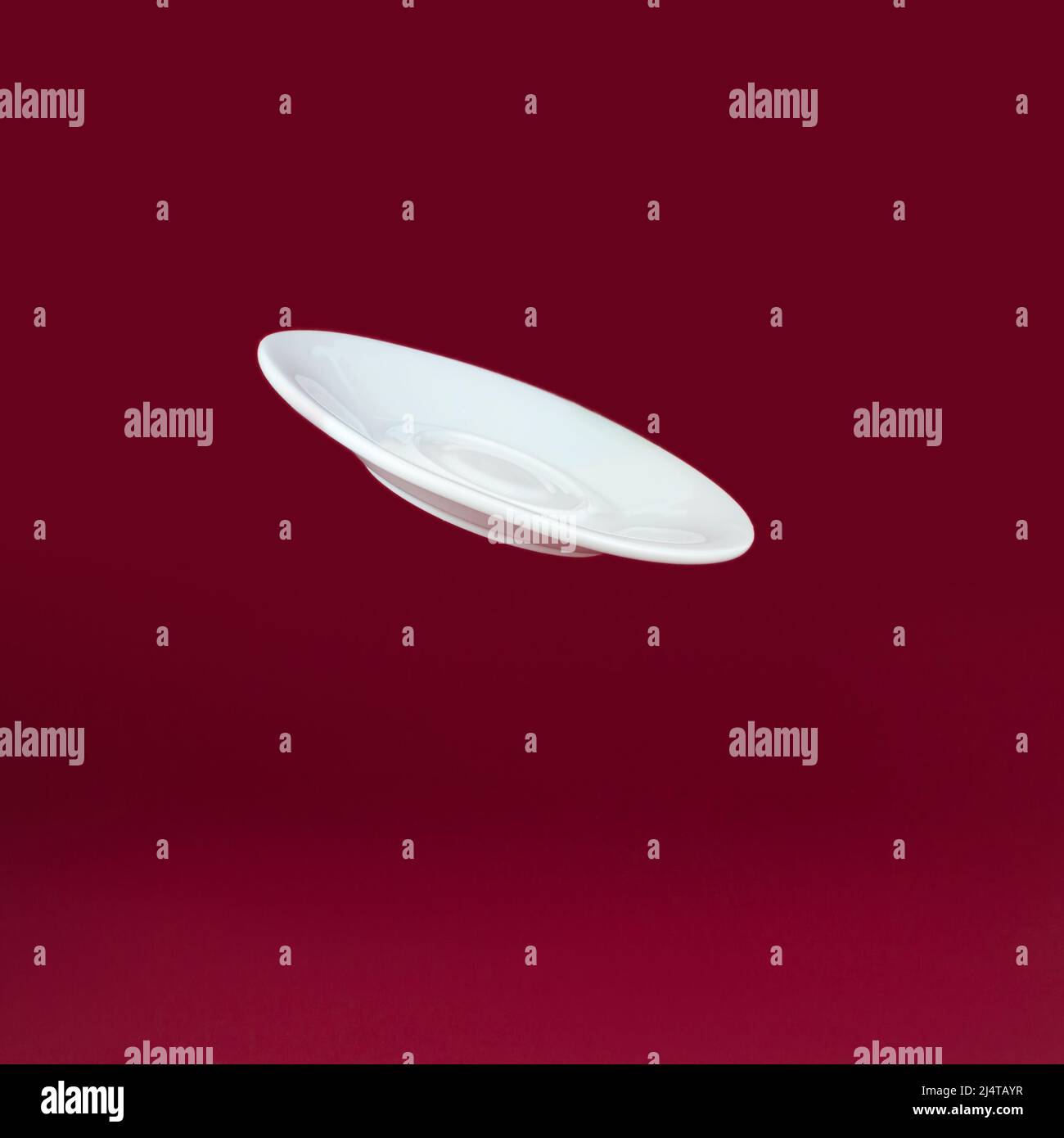 Flying White Porcelain plate on red background. Morning and addiction ...