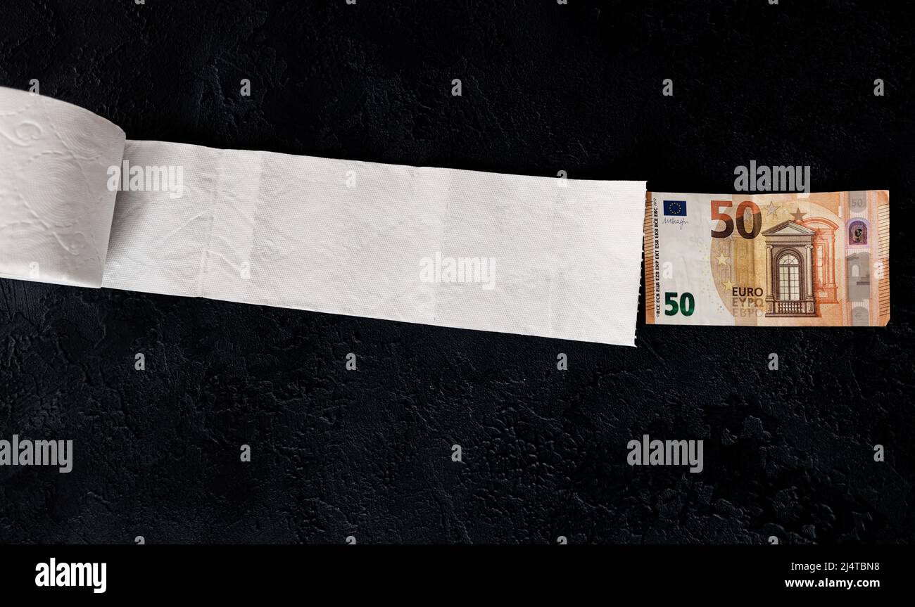 Toilet paper roll with 50 euro banknotes against textured background ...